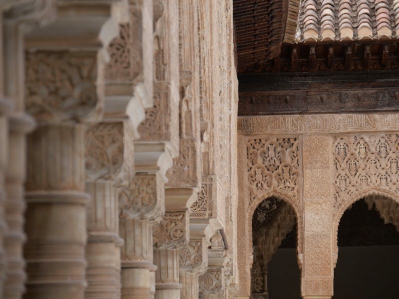 Close-up of intricate Moorish carved plaster patterns at the Alhambra