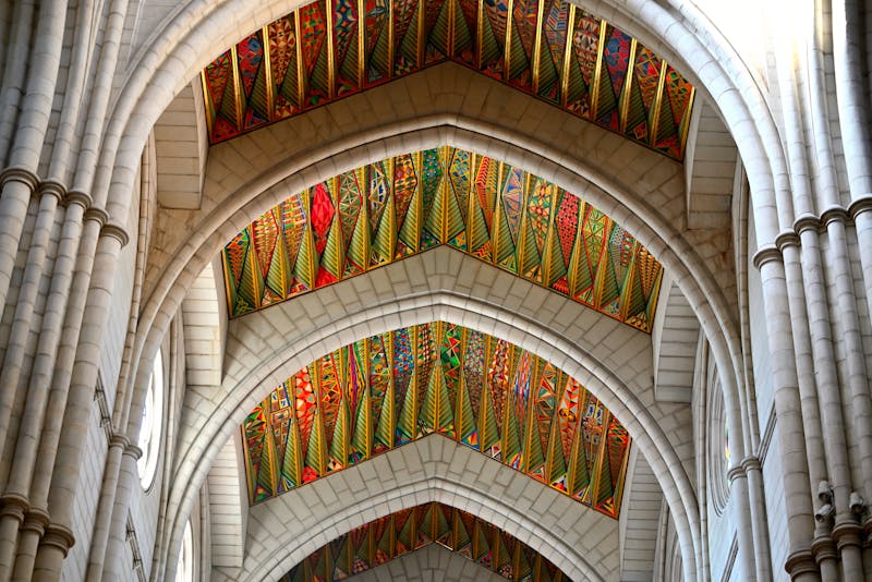 The colorful geometric patterned ceiling inside Almudena Cathedral in Madrid