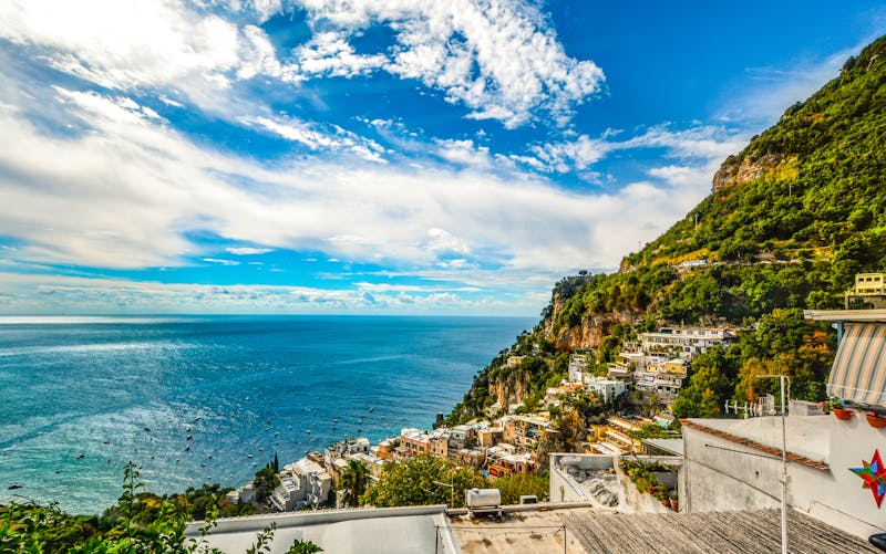 Aerial view of the Amalfi Coast showing blue sea and green hillsides