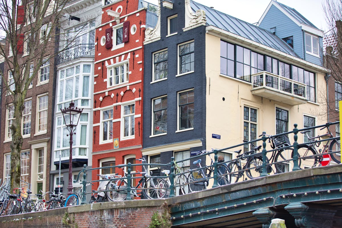 Bicycles on a bridge in Amsterdam with historic buildings