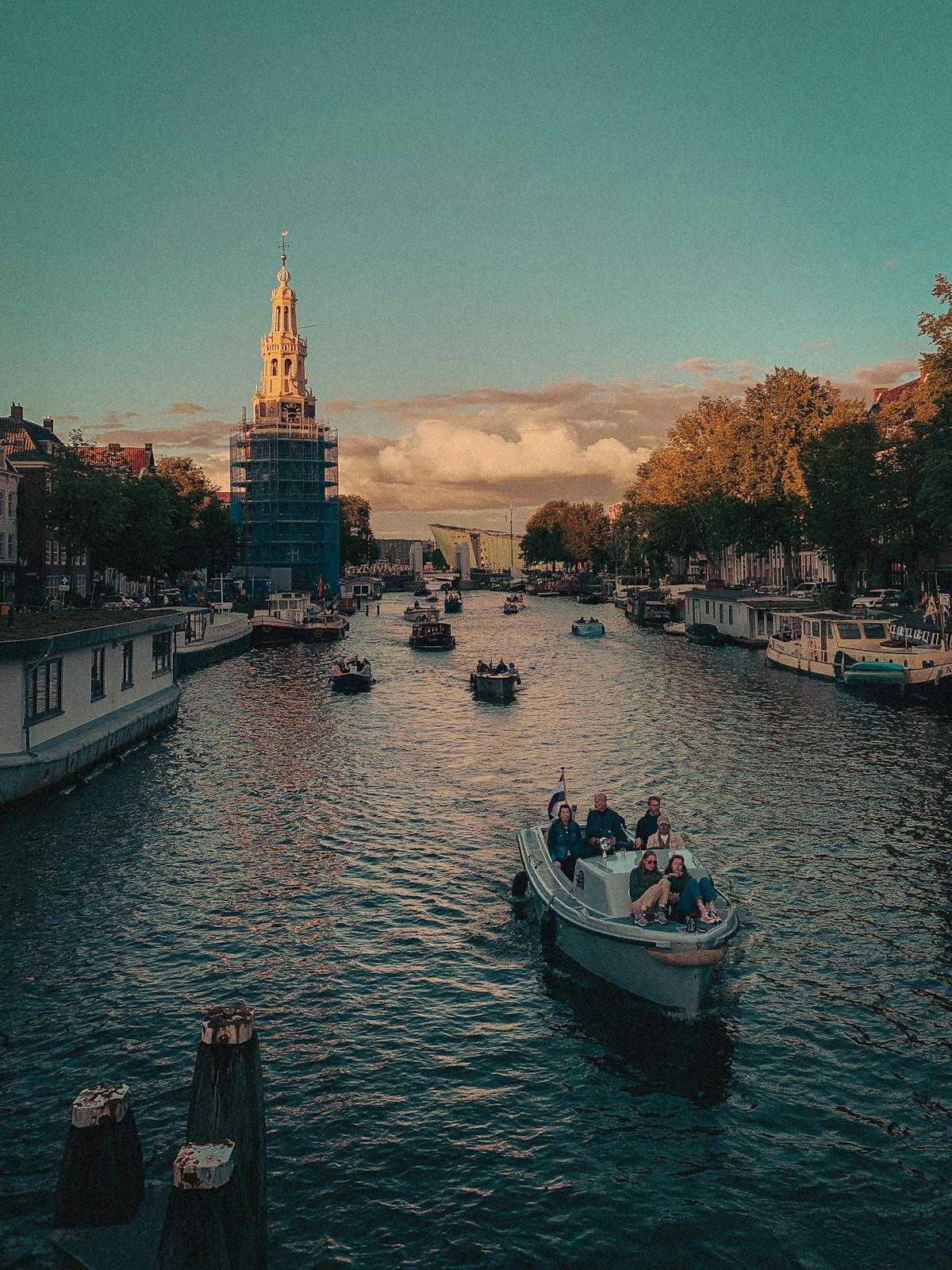 Amsterdam canal scene with boats and historic architecture on an autumn day