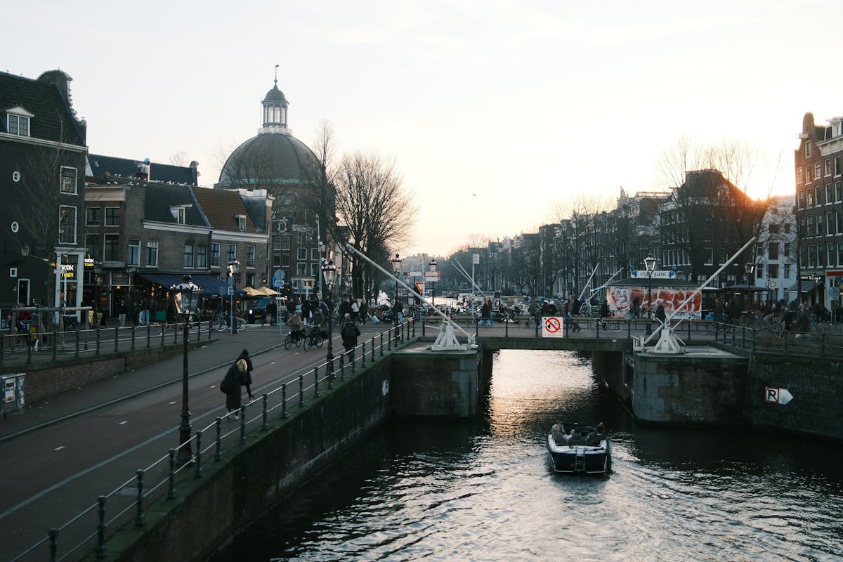 Charming view of Amsterdam canal and bridge at sunset
