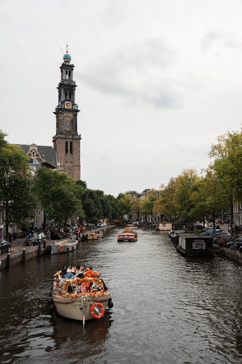 View of Amsterdam canal with the Westerkerk tower rising above traditional Dutch canal houses
