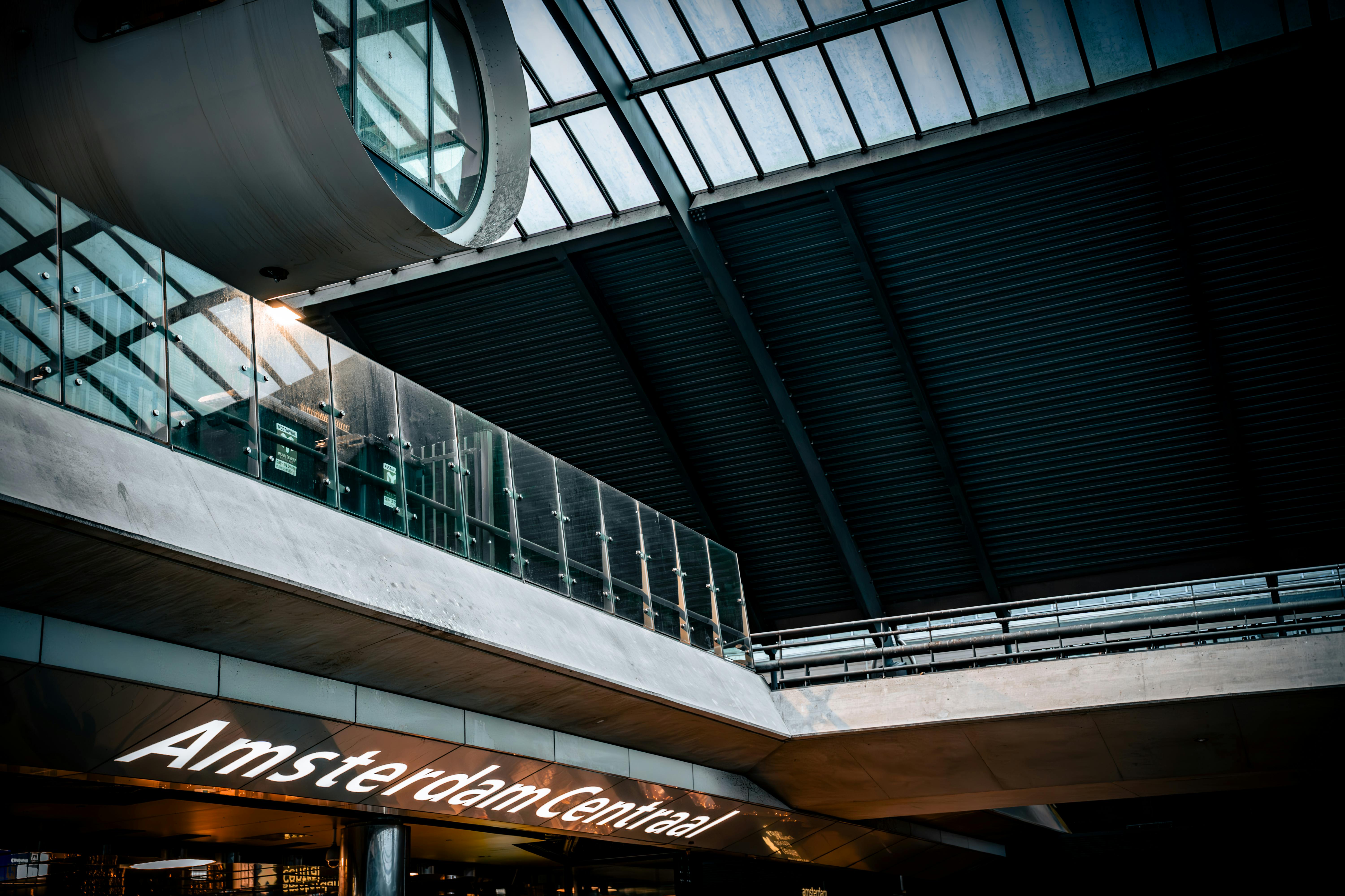 Interior of Amsterdam Centraal Station showing modern architectural design and glass ceiling