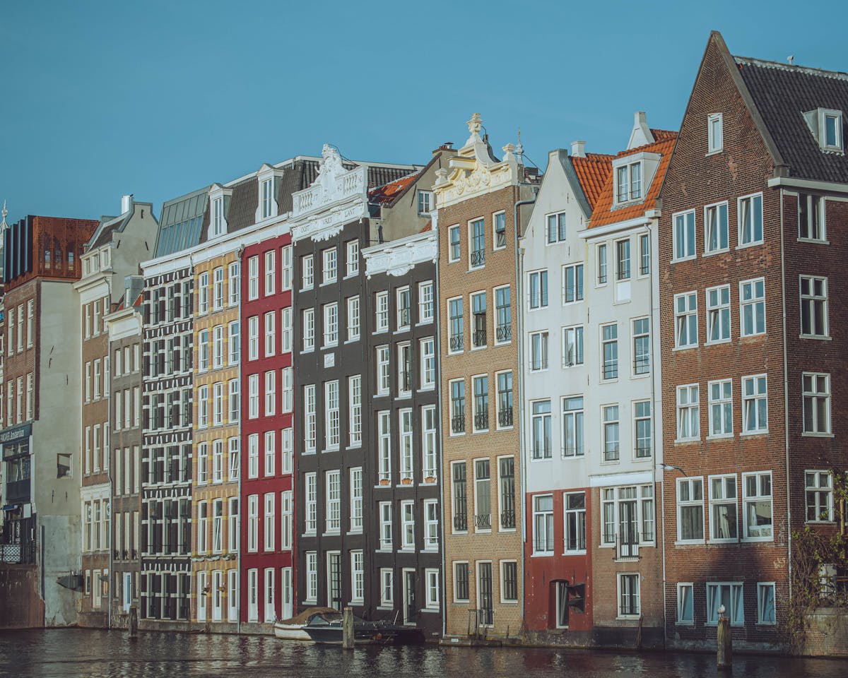 Colorful canal houses along Damrak in Amsterdam