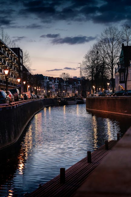 Beautiful canal in Amsterdam during twilight with reflections on water