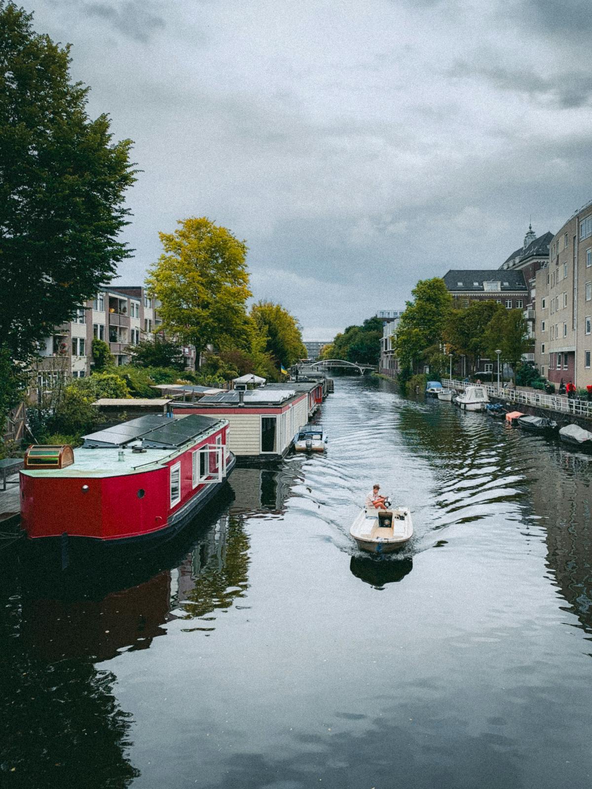 Houseboats lining a quiet Amsterdam canal