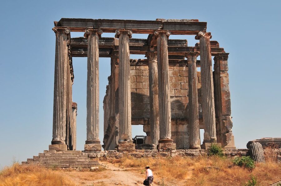 Towering ancient Greek columns under clear blue sky