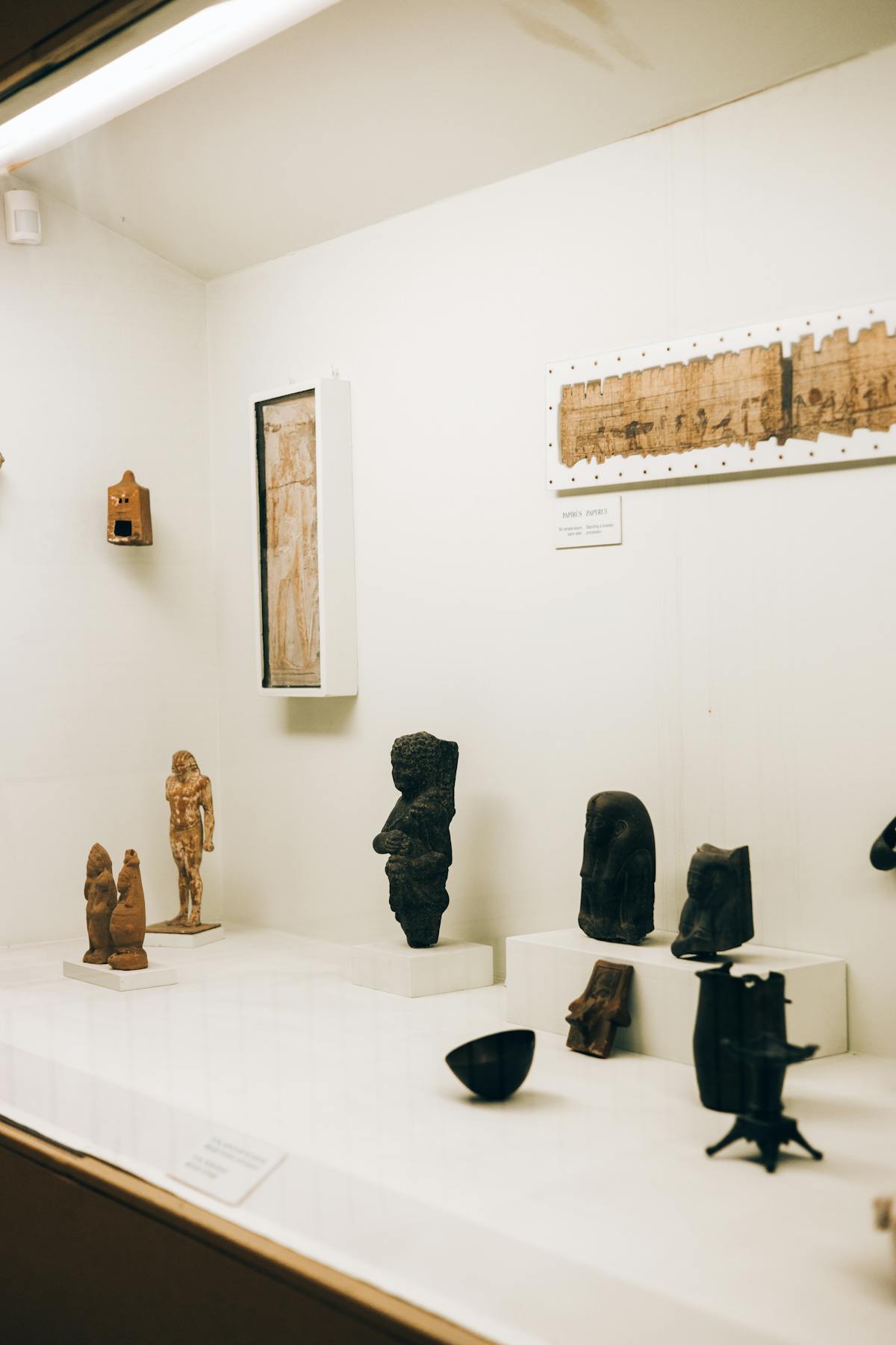 Collection of ancient figurines and archaeological artifacts in a museum exhibit