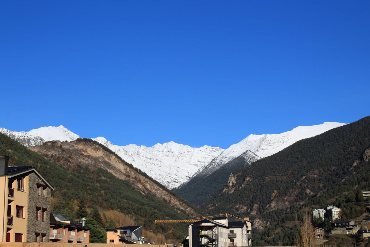 Stunning snow-capped mountains under clear blue sky in La Massana, Andorra