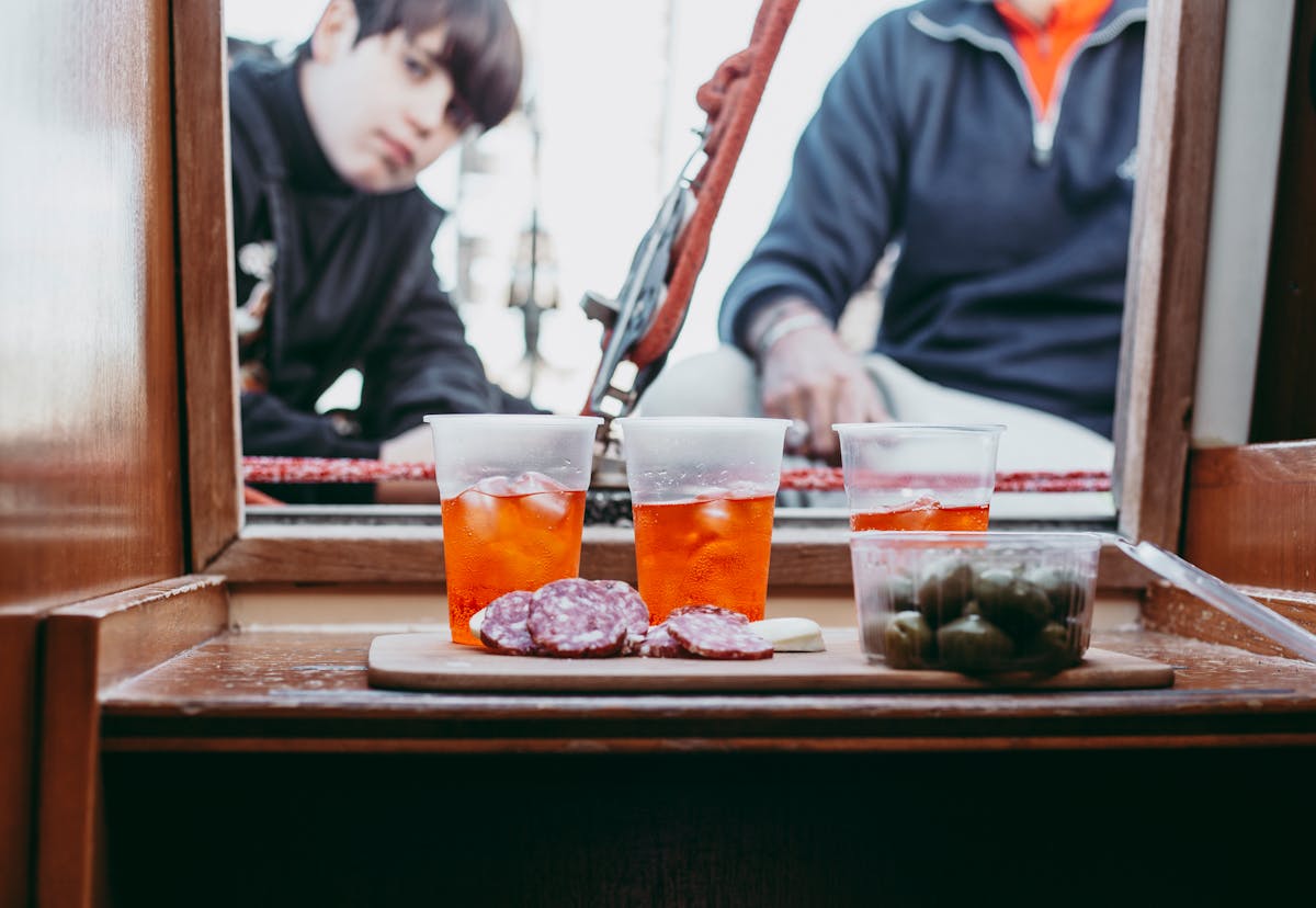 Refreshing aperitif with drinks olives and salami on a boat