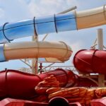 Colorful twisting water slides at an outdoor water park under blue sky