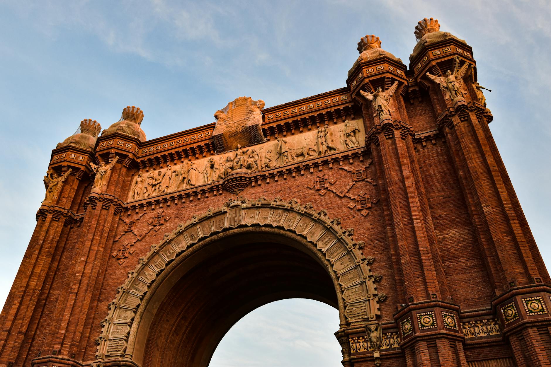 Arc de Triomf in Barcelona with blue sky and wide pedestrian avenue