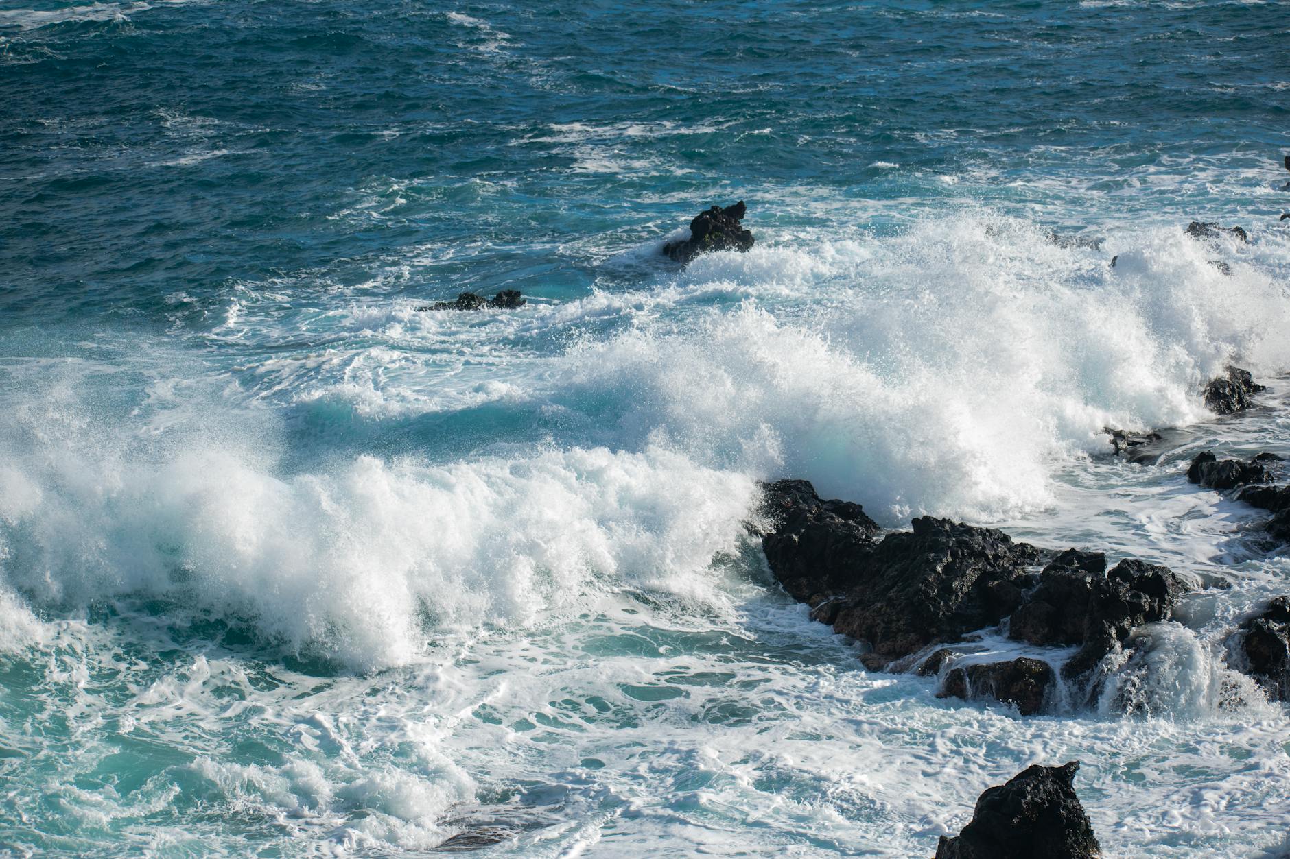 Ocean waves crashing onto volcanic rocks in Canarias Spain