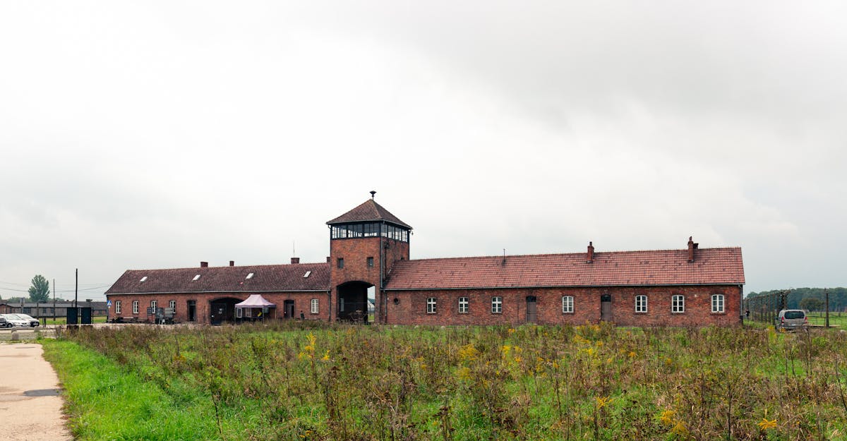 Auschwitz-Birkenau memorial entrance with overcast skies