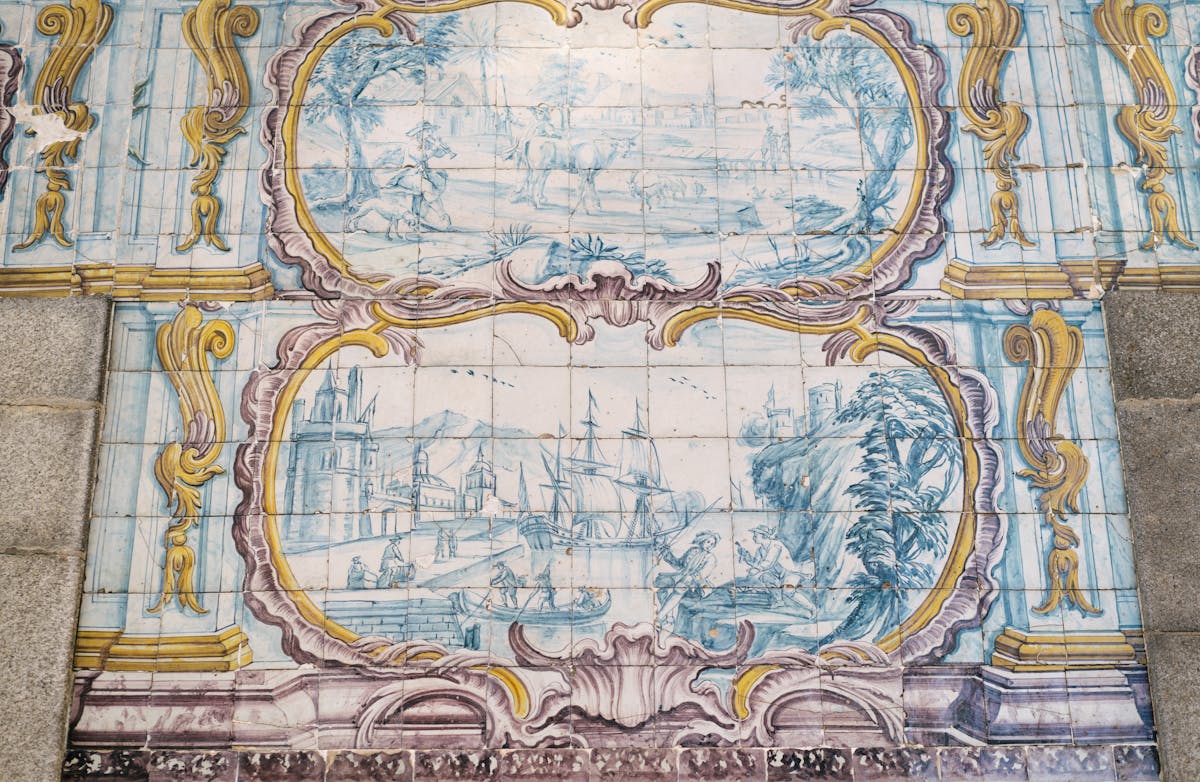 Painted azulejo ceramic tiles showing a historic ship in port on a building wall in Porto Portugal