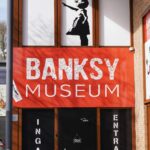 Entrance to a Banksy museum featuring the iconic girl with red balloon artwork