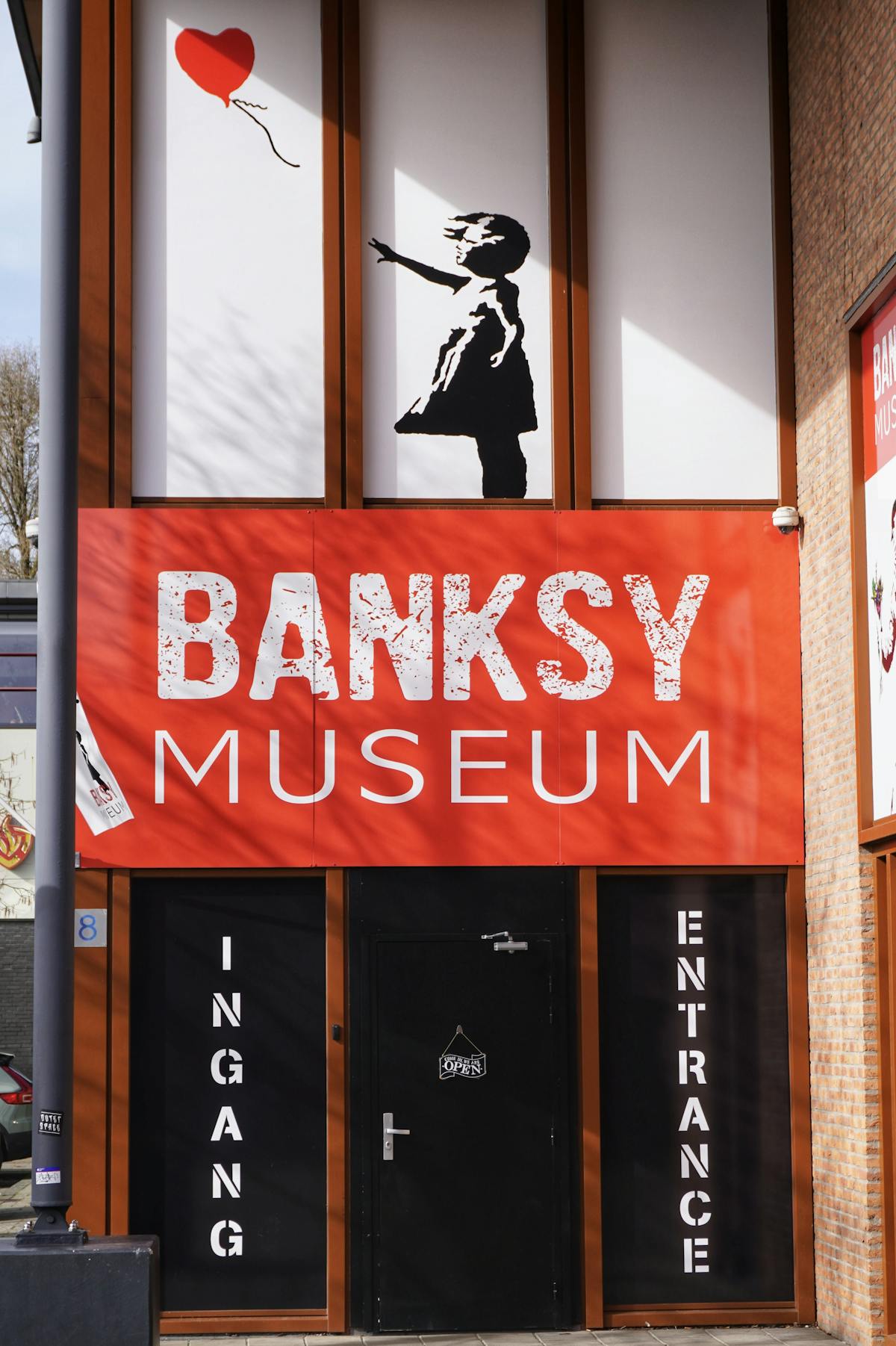 Entrance to a Banksy museum featuring the iconic girl with red balloon artwork