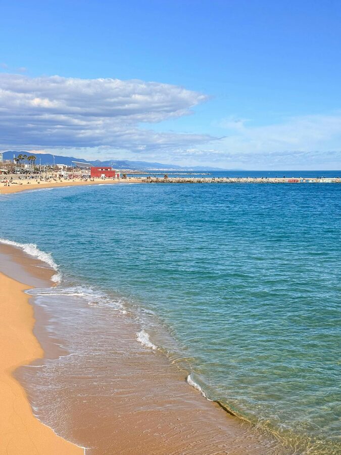 Barcelona beach with clear blue skies and gentle Mediterranean waves