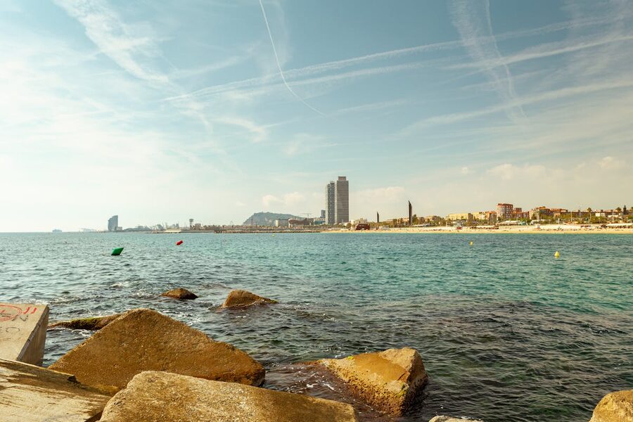 Barcelona beachfront with city skyline and clear blue Mediterranean water