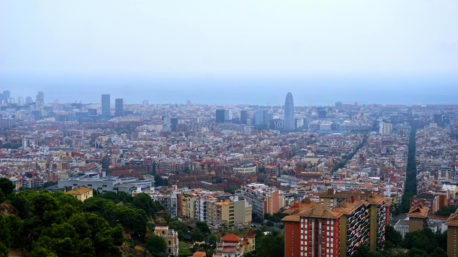 Aerial view of Barcelona cityscape with Mediterranean Sea in background