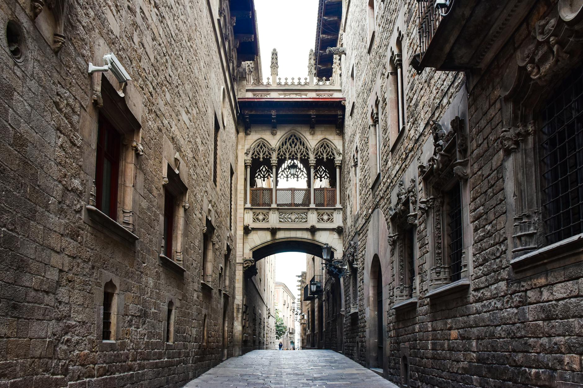 Narrow cobblestone street with stone archway in Barcelona's Gothic Quarter