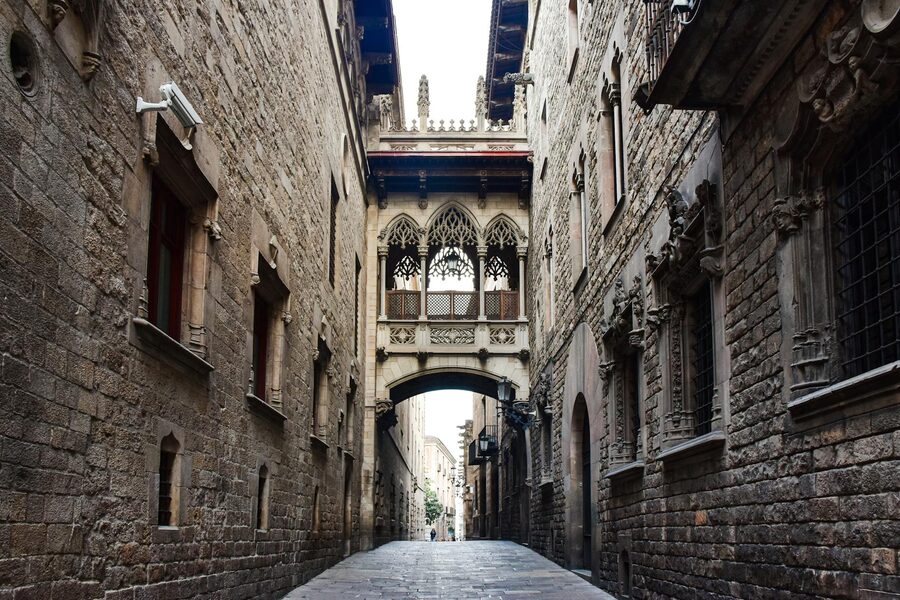 Narrow cobblestone street in Barcelona Gothic Quarter with historic architecture