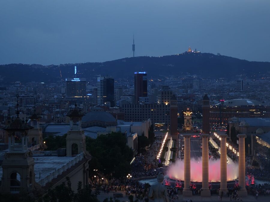 Aerial view of Barcelona with Montjuic fountain and hill at twilight