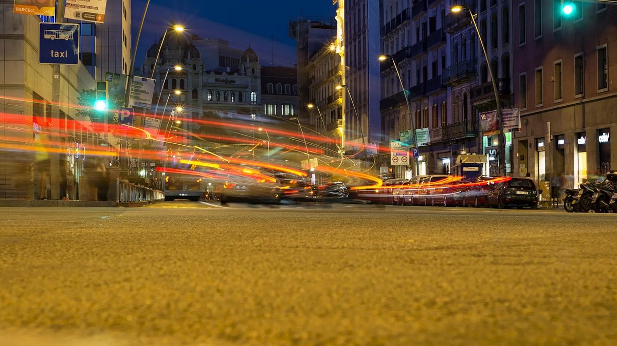 Barcelona street with neon lights in the evening