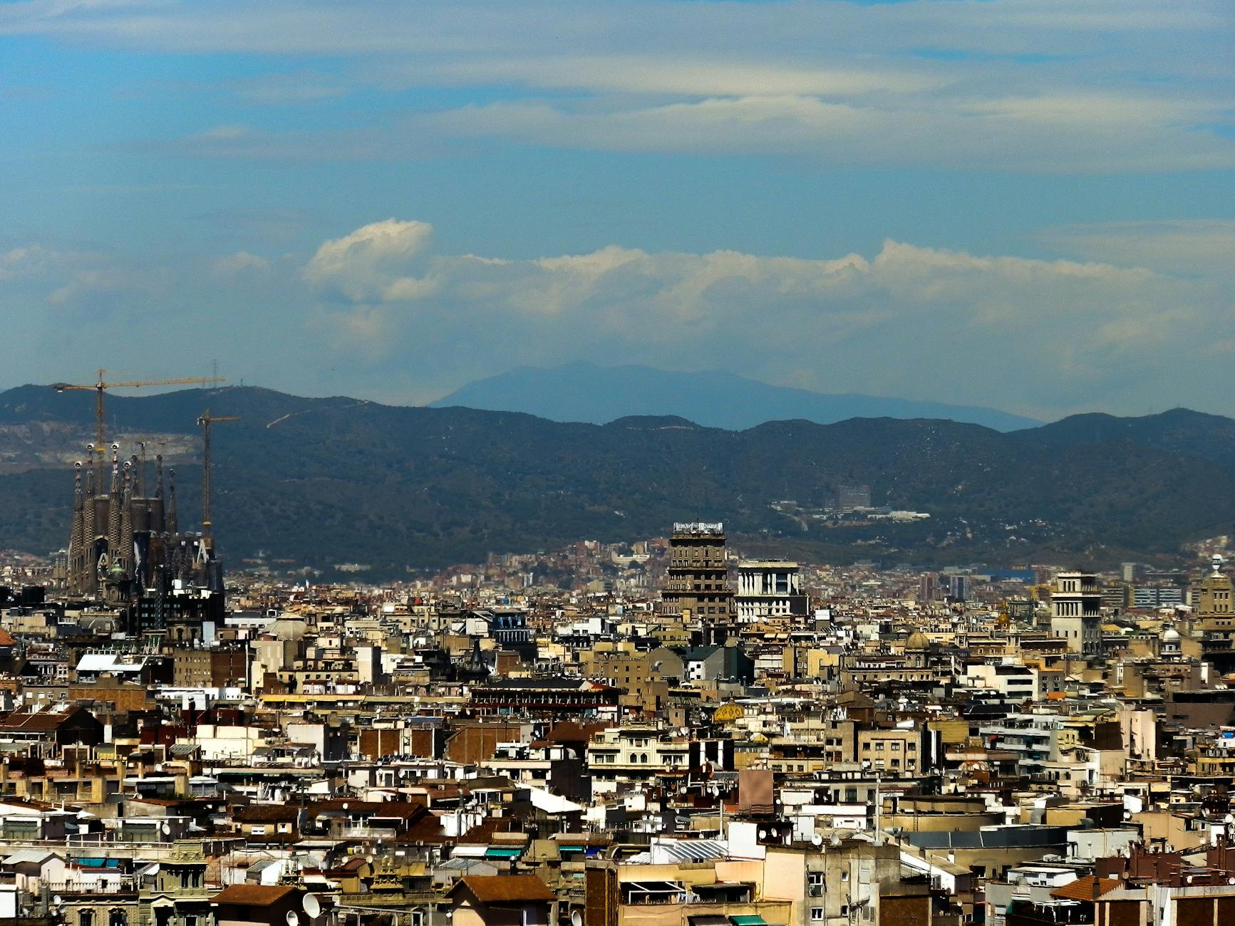 Panoramic view of Barcelona with Sagrada Familia and Mediterranean Sea in the distance