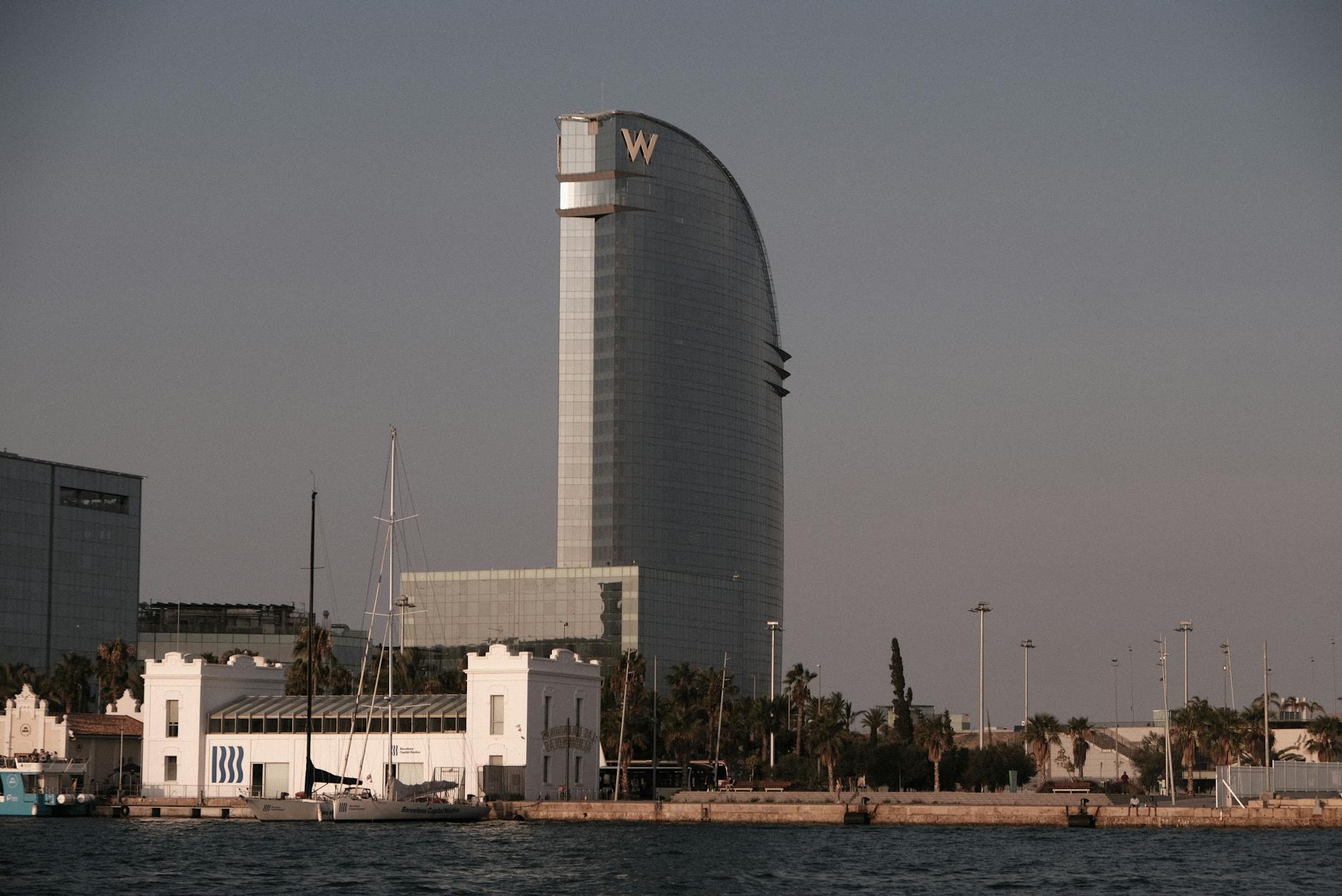 Port Olimpic in Barcelona with boats and sunset sky