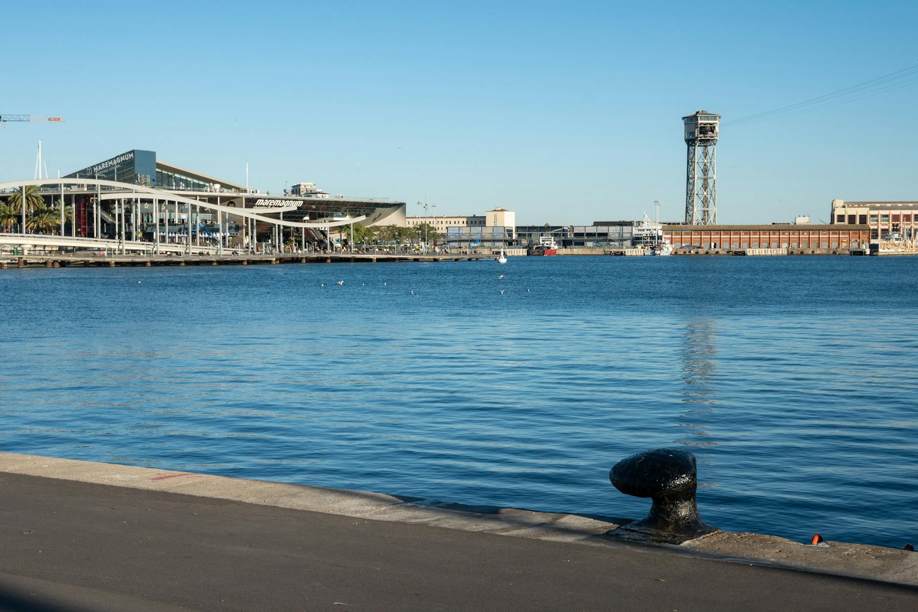 Panoramic view of Barcelona Port Vell waterfront with boats and historic buildings
