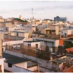 Aerial view of Barcelona rooftops showing diverse architecture at twilight