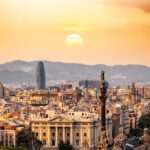 Panoramic view of Barcelona skyline at sunset with iconic landmarks visible