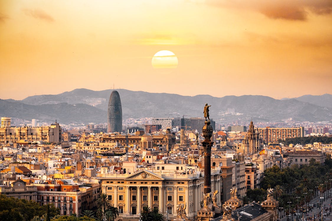 Panoramic view of Barcelona skyline at sunset with iconic landmarks visible