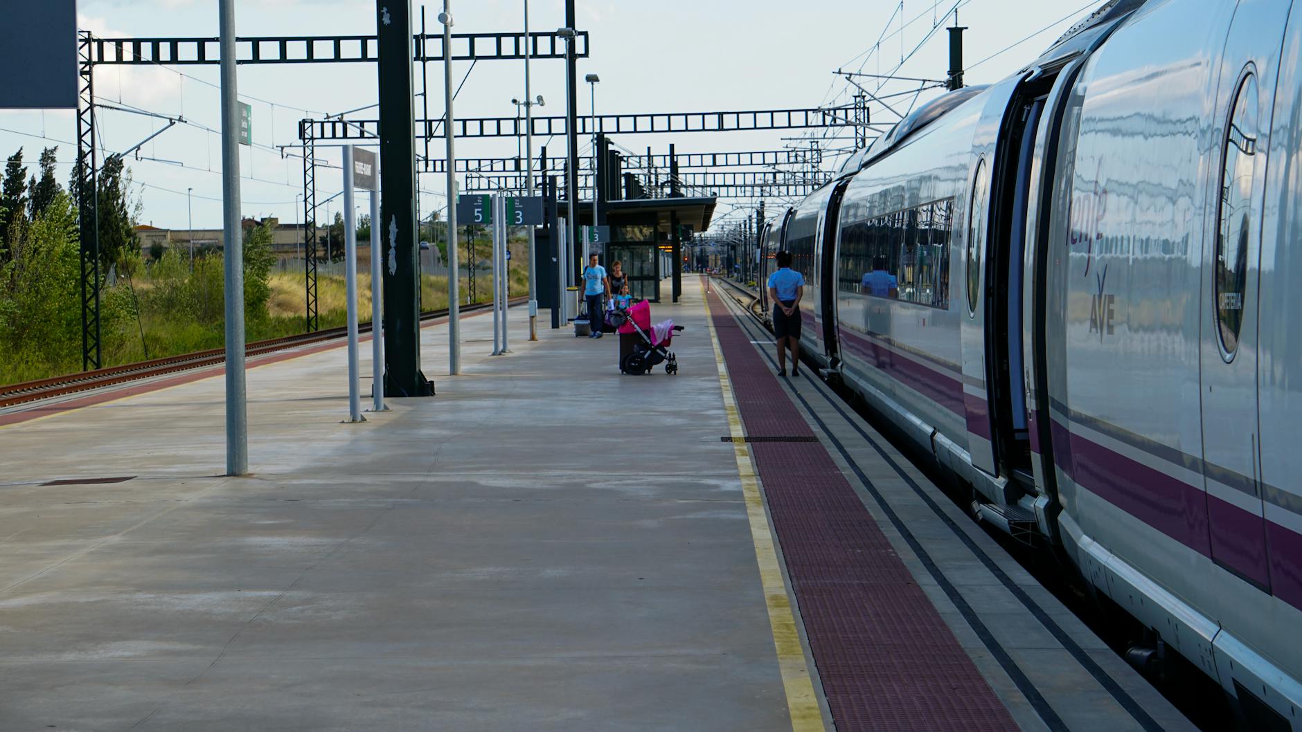 Barcelona train station platform with passengers waiting for regional trains