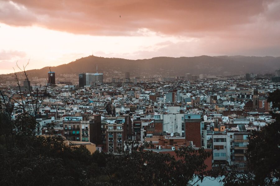 Aerial panoramic view of Barcelona urban skyline against dramatic sunset