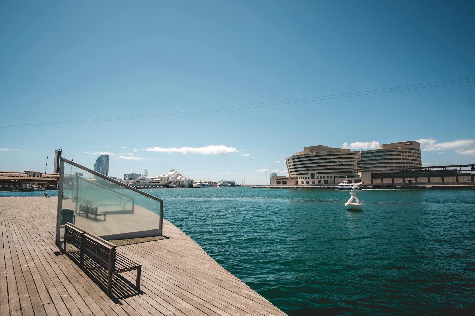 Barcelona waterfront with modern architecture and wooden pier