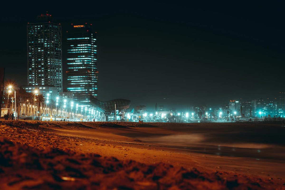 Barcelona waterfront with illuminated buildings at night