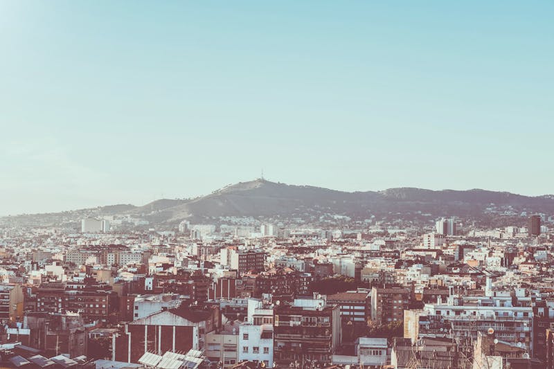 Panoramic view of Barcelona urban landscape with Montjuic hill in the background