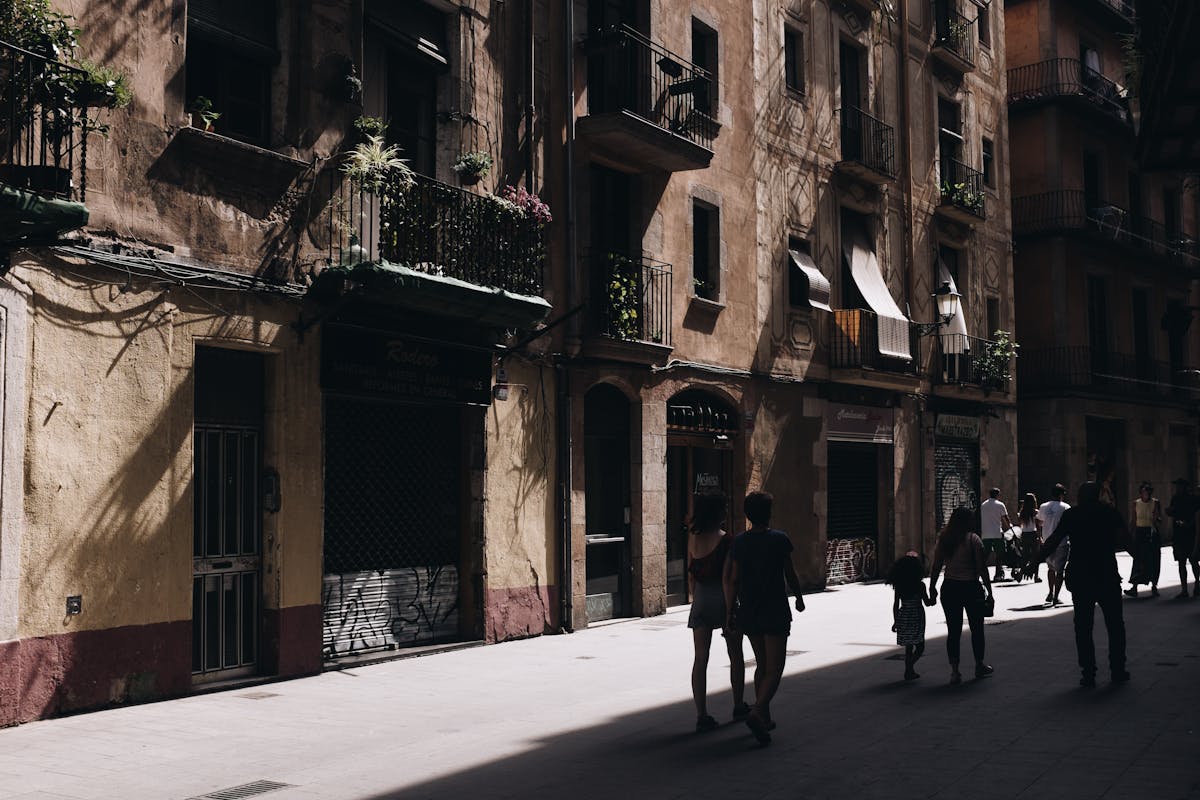 Historic street in Barcelona with architectural facades and shadow patterns
