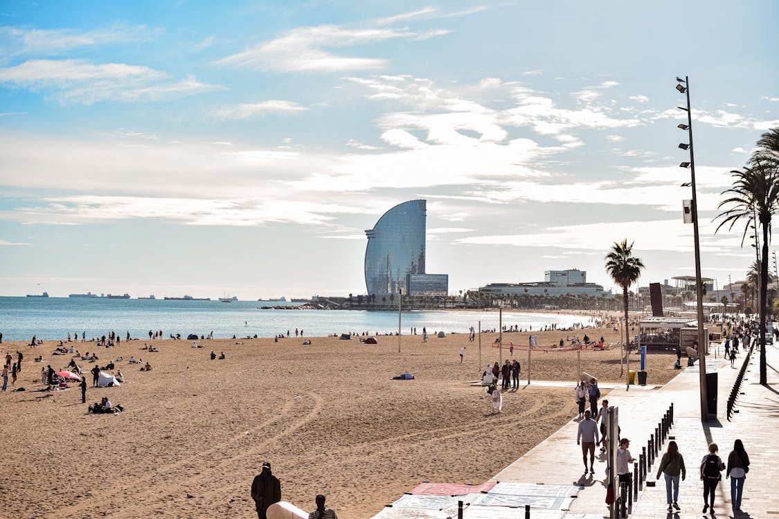 View of Barceloneta Beach in Barcelona with W Hotel and sunbathers