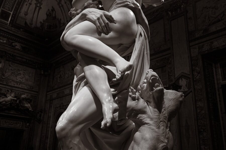 Dramatic baroque marble sculpture depicting classical themes in a Roman gallery setting