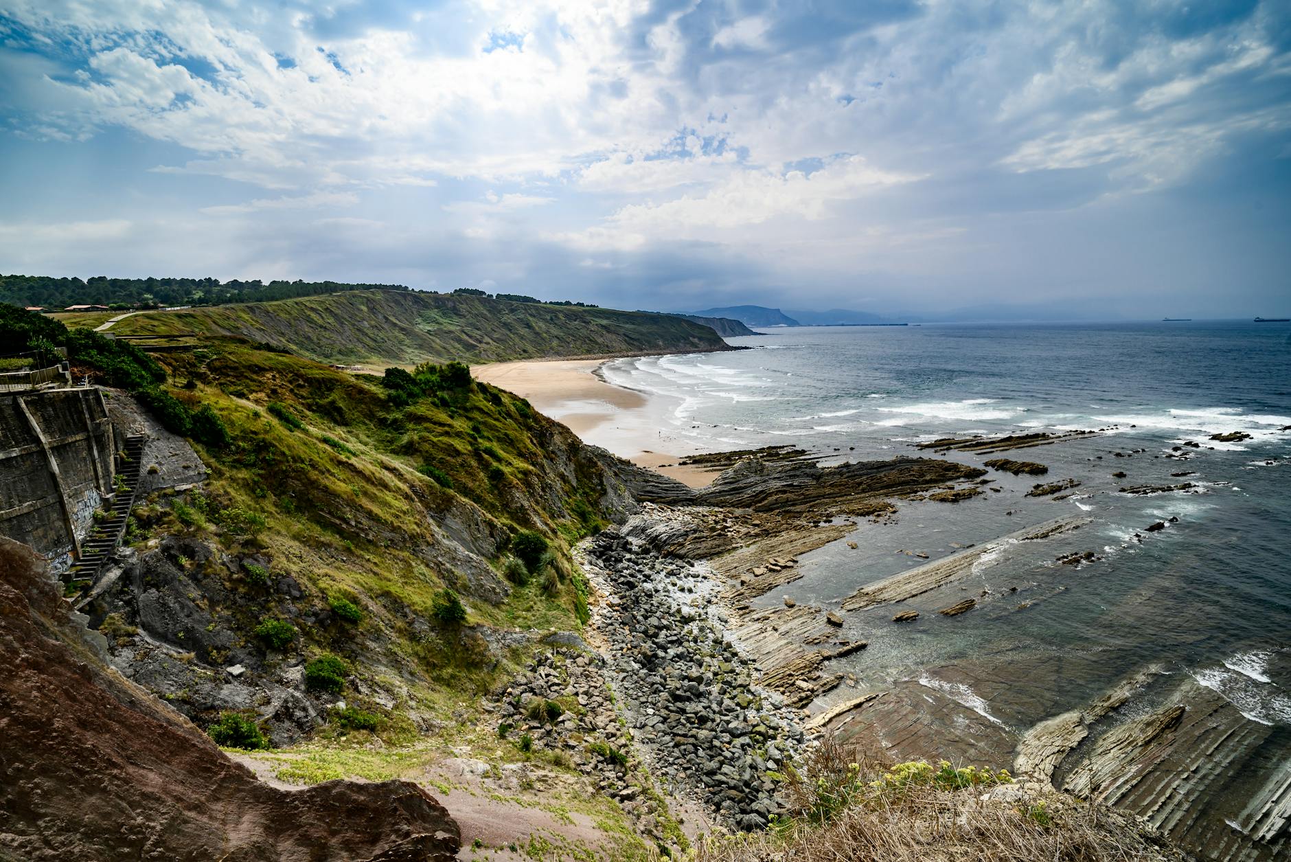 Dramatic coastal cliffs and surf at Sopelana beach on the Basque Country coastline Spain