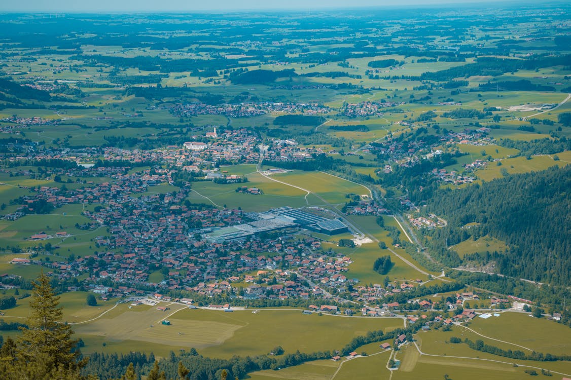 Aerial view of a traditional Bavarian village in a green alpine valley