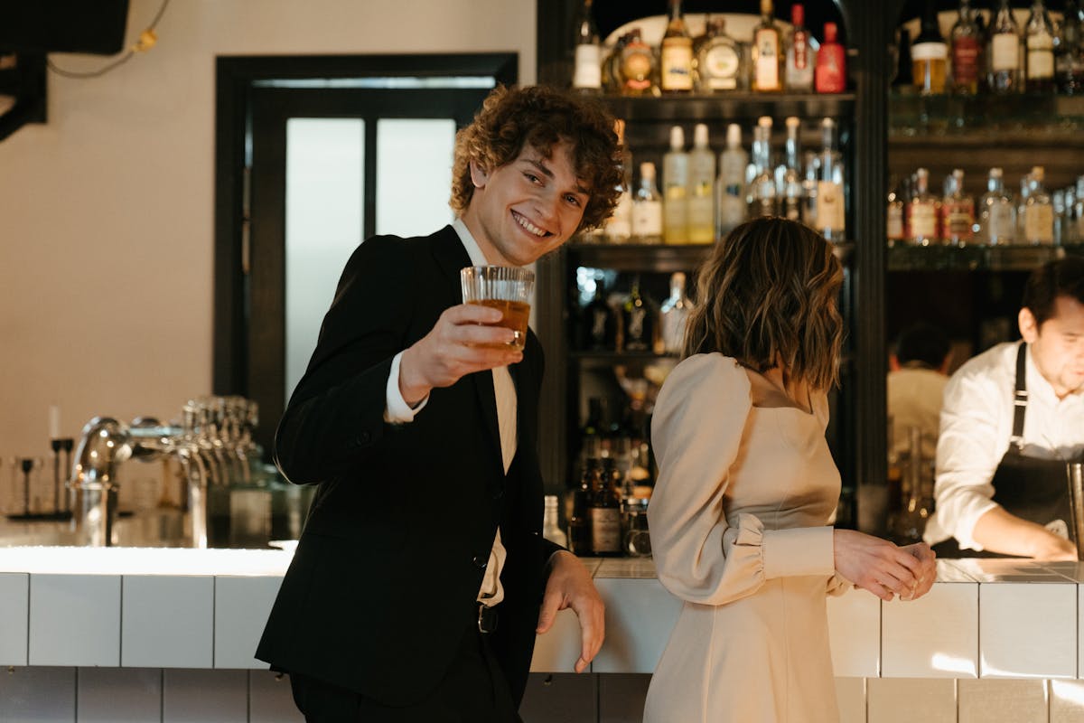Man and woman enjoying drinks at stylish bar