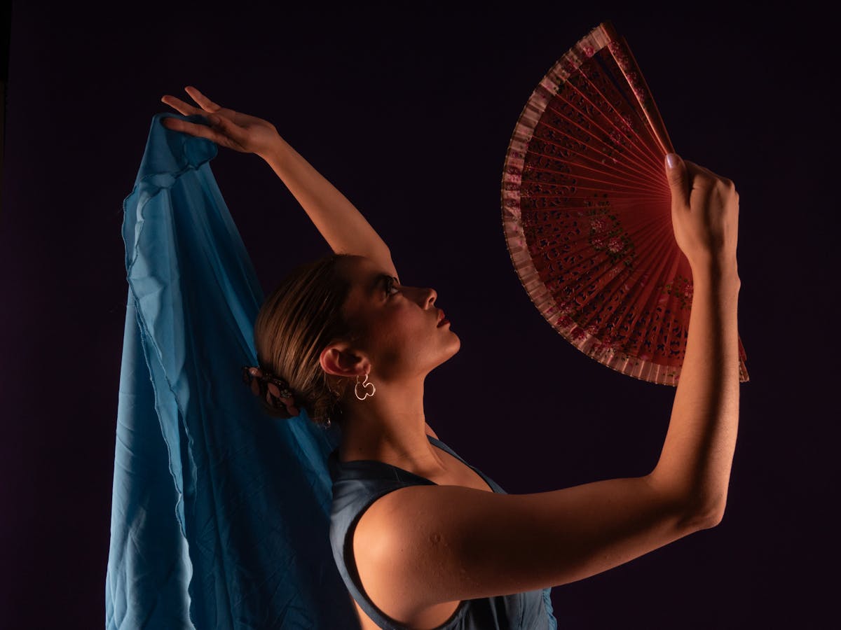 Elegant flamenco dancer with fan performing