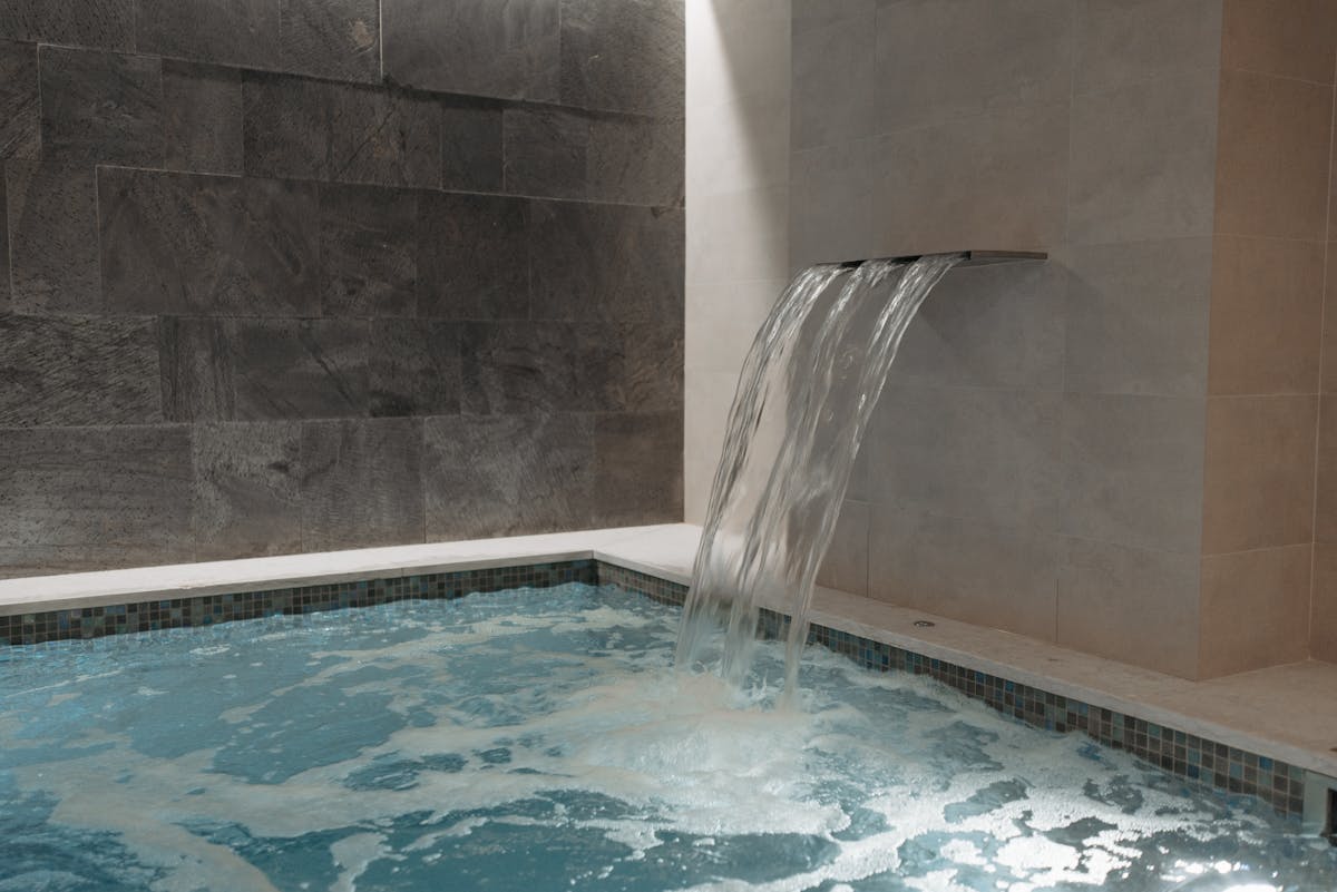 Waterfall feature in indoor pool spa