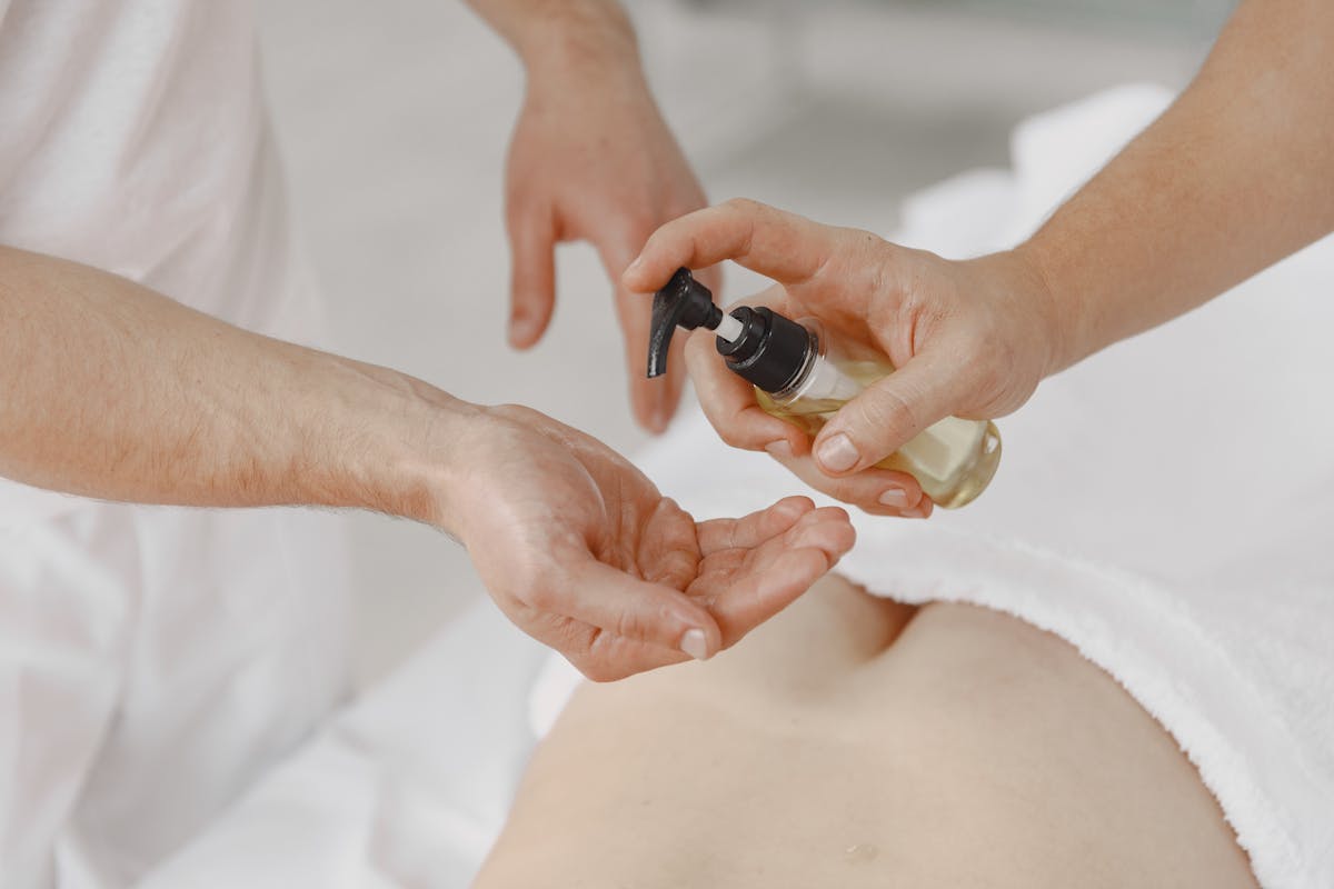 A person applying essential oils for massage