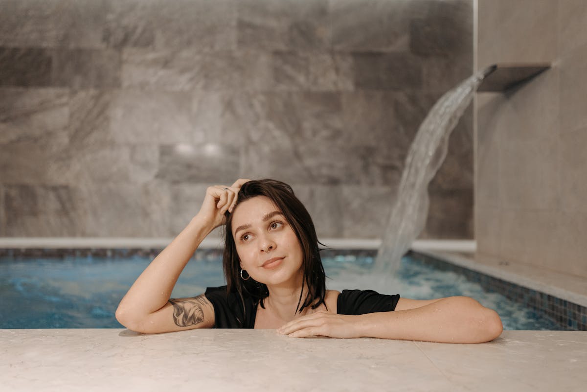 A woman relaxing in an indoor pool